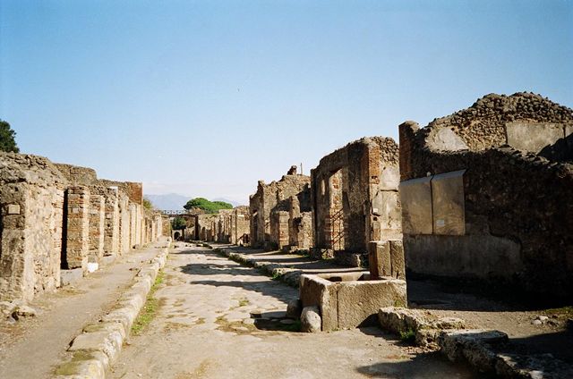 Via di Nola, Pompeii. May 2010. Looking east between V.3 and IX.8 along ...