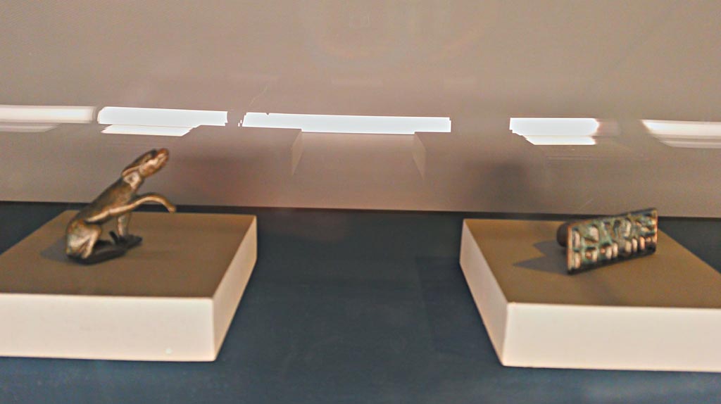 IX.13.1-3 Pompeii. December 2019. Bronze statuette of dog, and bronze ...